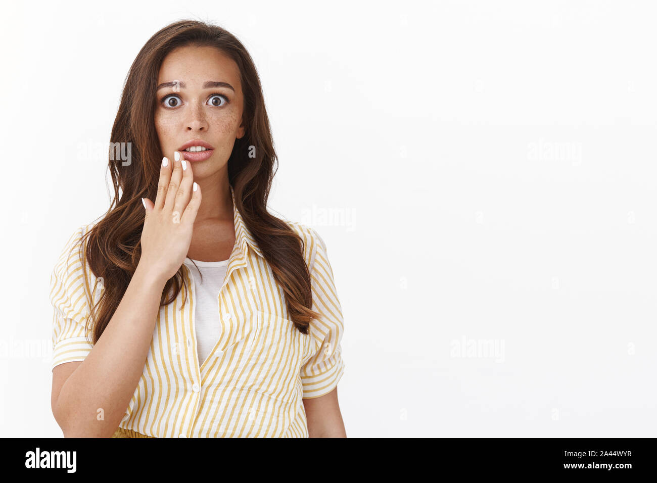 Concerned impressed young brunette woman gasping shocked, hold hand ...