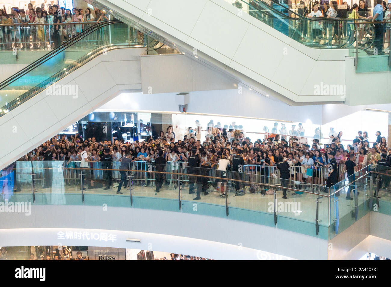 Chinese fans crowd a shopping mall to support singer and actor Karry ...