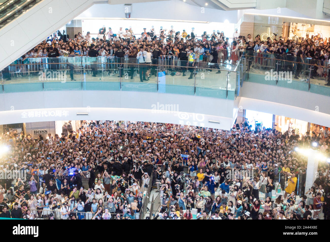 Chinese fans crowd a shopping mall to support singer and actor Karry ...