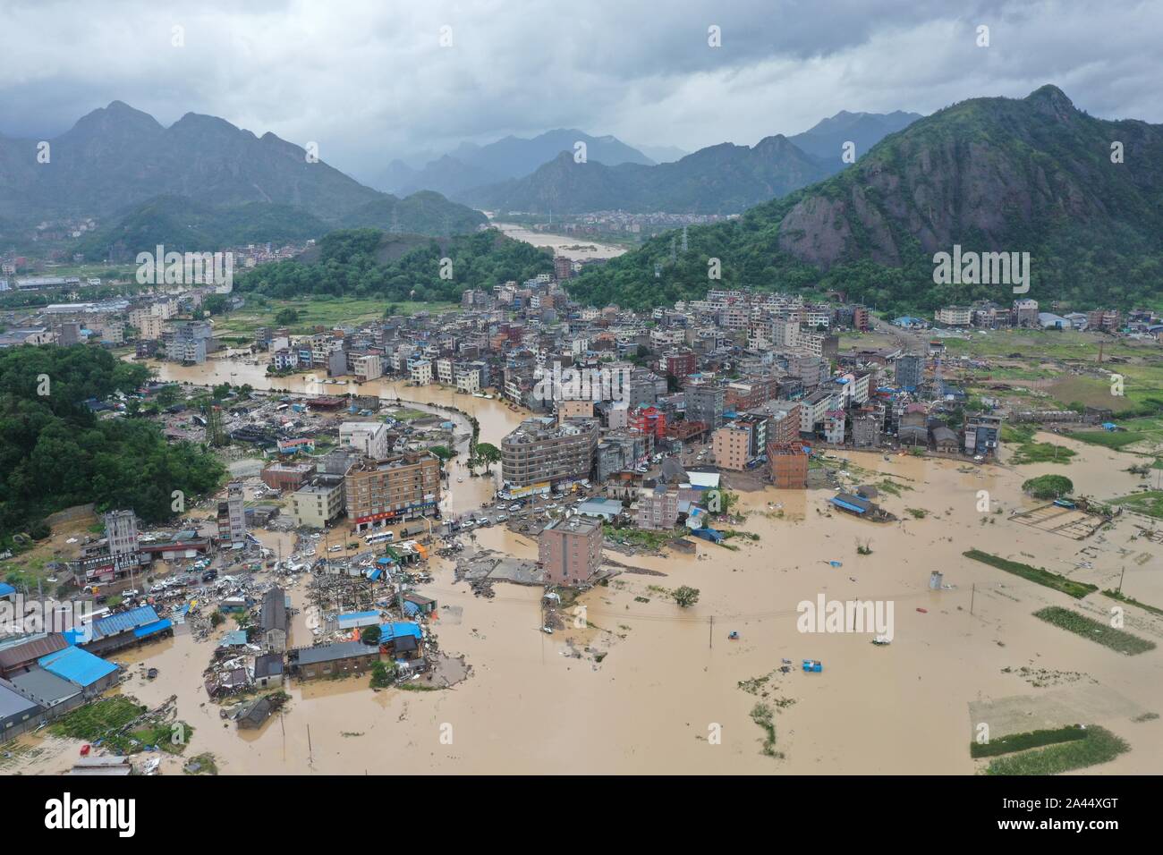 The residential buildings and fields are submerged in floodwater after ...