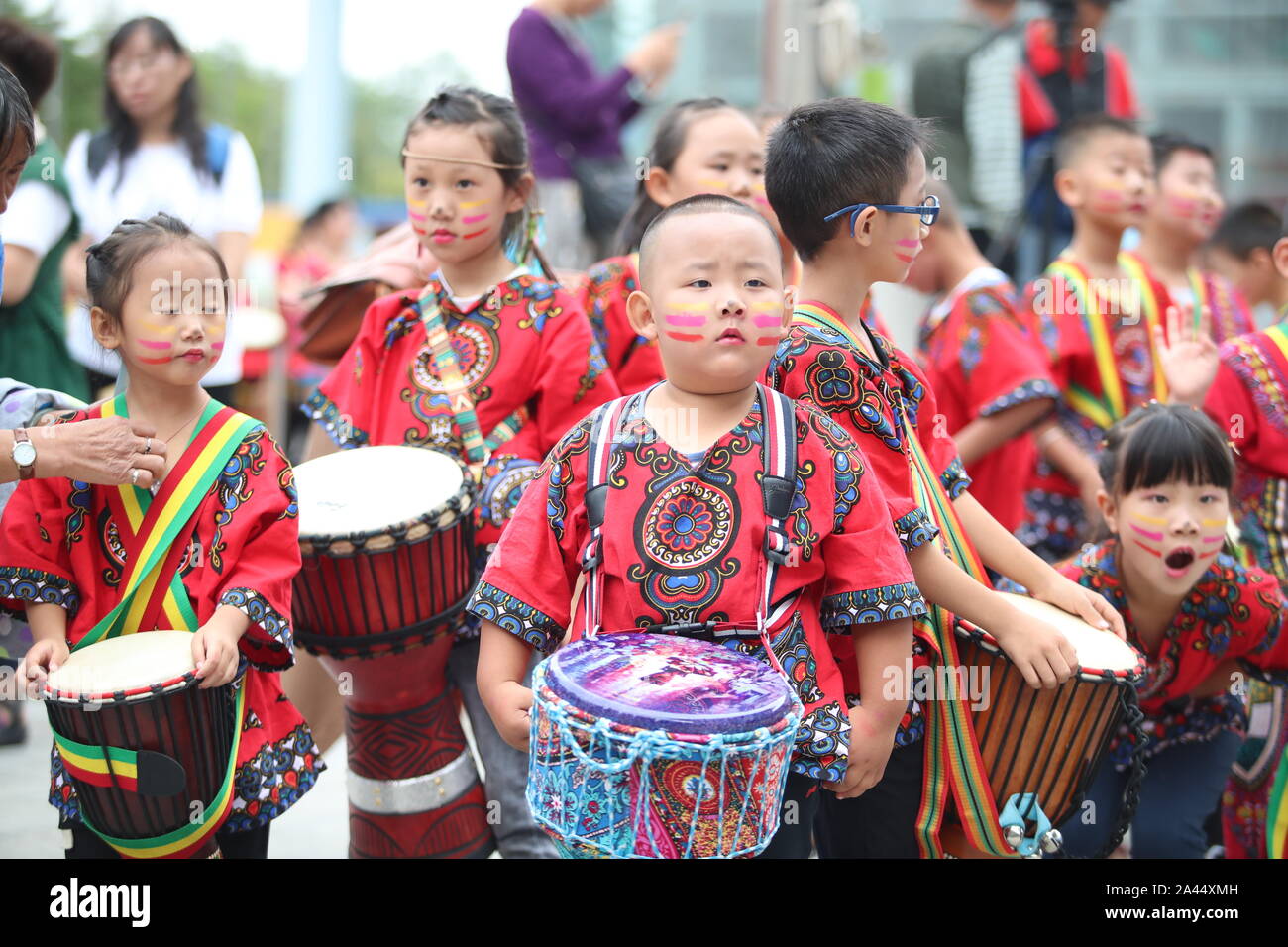 Chinese ethnic people dressed in traditional costumes perform during ...