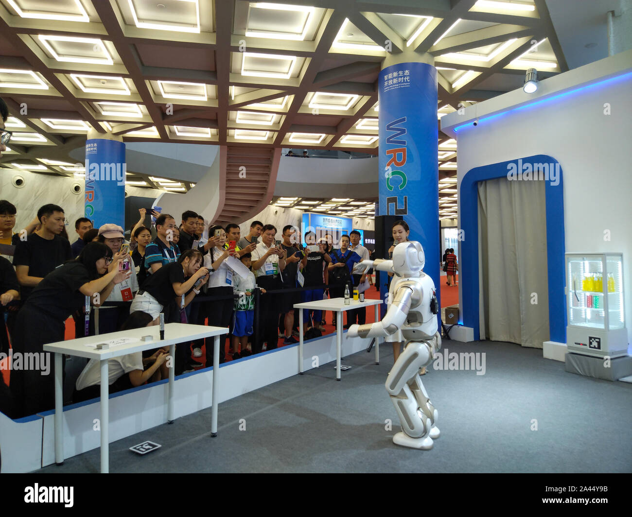 Visitors take photos of a robot dancing at the 2019 World Forum on ...