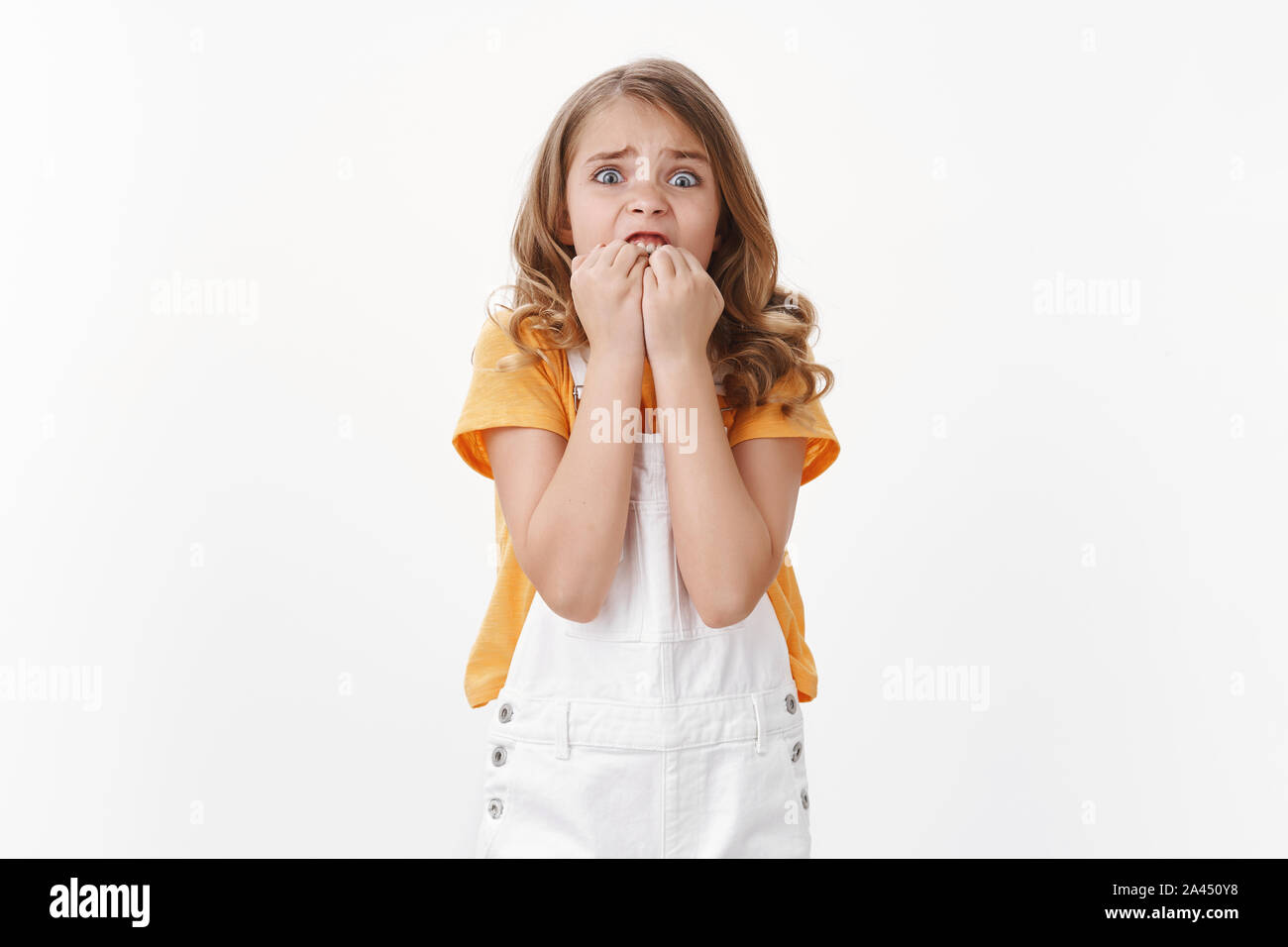 Scared innosent timid little girl with blond hair and blue eyes, panic ...