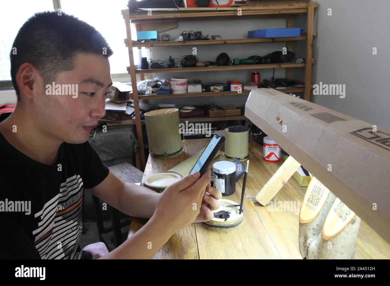 Chinese man Ni Chenkai uses waste tree trunk to make a wooden QR code via a mobile payment ...