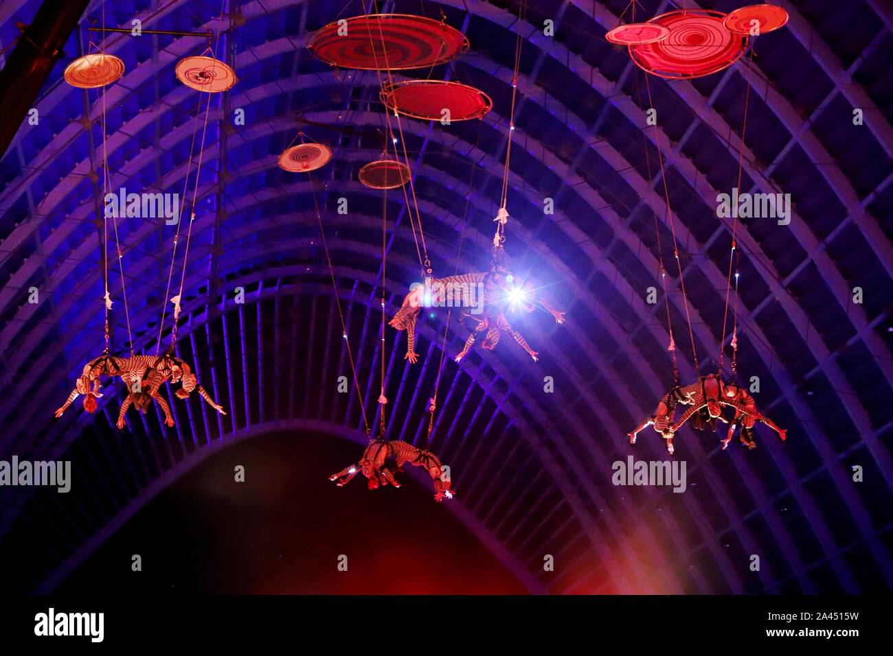 Accompanied by live rock music, aerialists of Voala, a Spanish circus ...