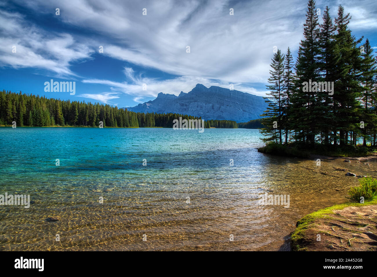 Beautiful Two Jake Lake on a sunny day with clouds in the sky and Mount ...