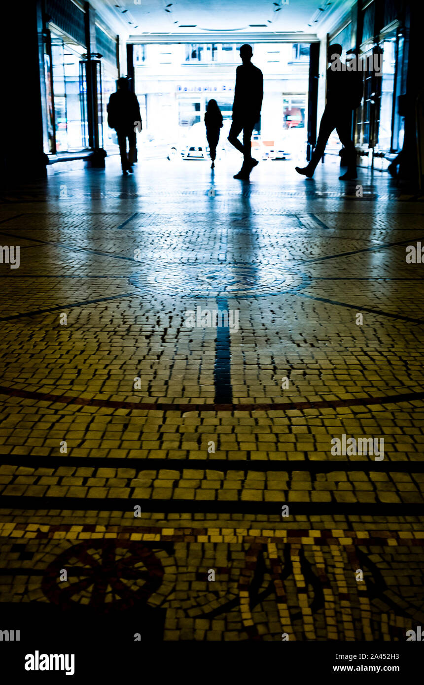 silhouettes of people walking in an underpass Stock Photo - Alamy