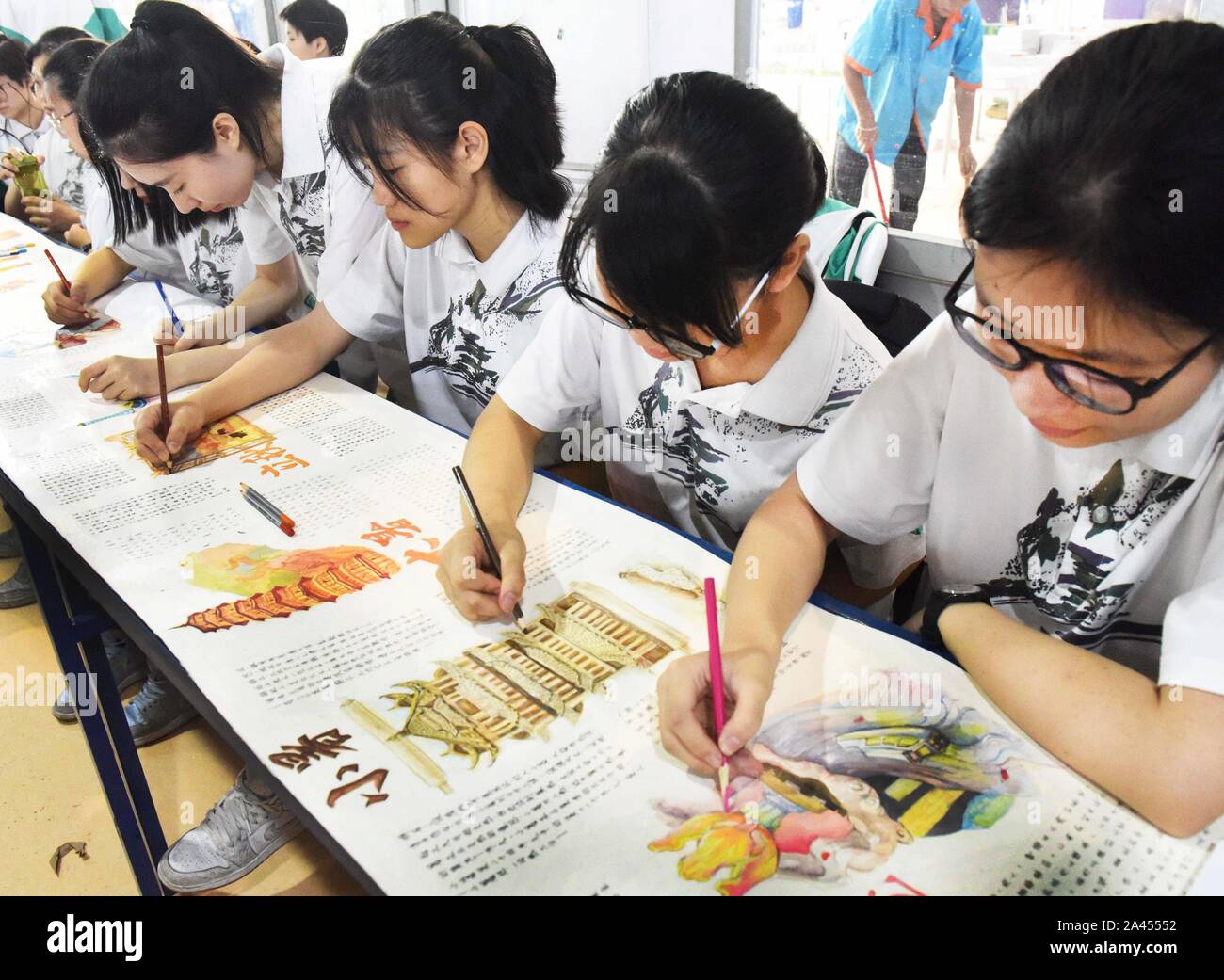 Students design and draw during Chinese self-designed newspaper ...