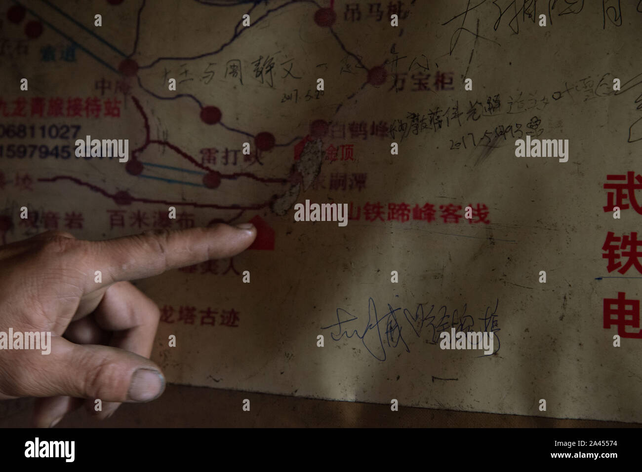 Lin shows his hotel in a map in Luxi county, Pingxiang city, east China ...