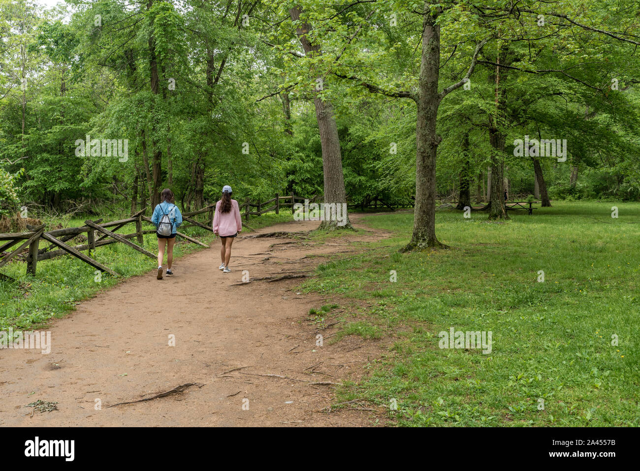 Mother with pink sweater and teen daughter walking down path in Great ...