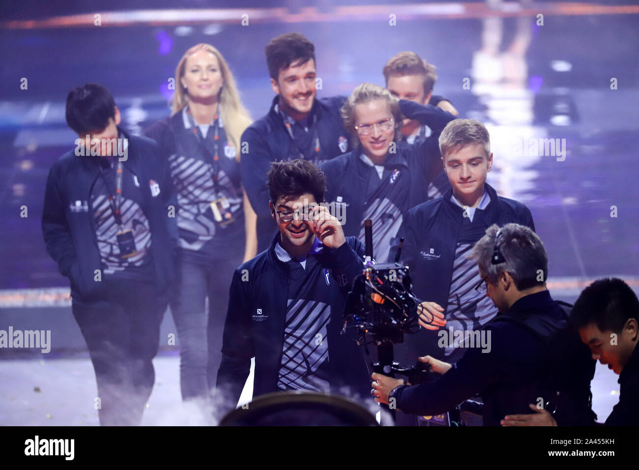 Players of Europe's OG pose for photos with their trophy after winning ...