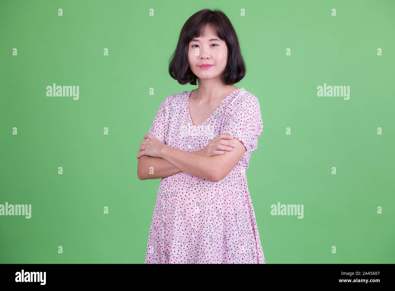 Portrait Of Beautiful Asian Pregnant Woman With Arms Crossed Stock