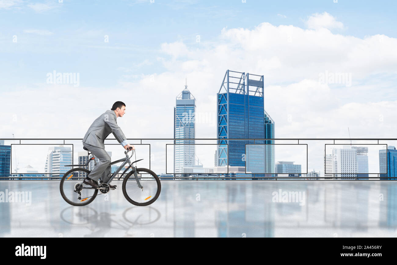 Man riding bicycle on penthouse balcony Stock Photo - Alamy