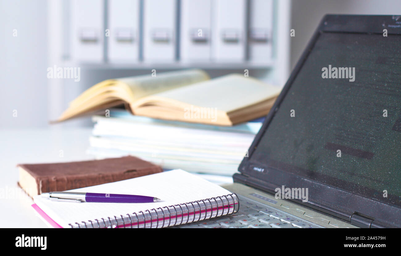 Office table with blank notepad and laptop Stock Photo - Alamy