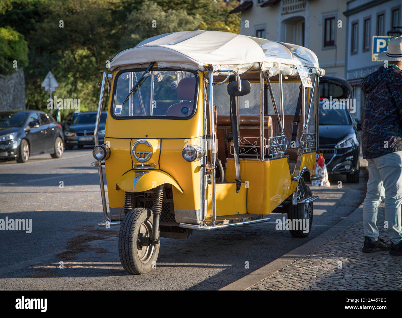 SINTRA, PORTUGAL - 11TH AUGUST 2019: A bright yellow tuk-tuk on a road ...
