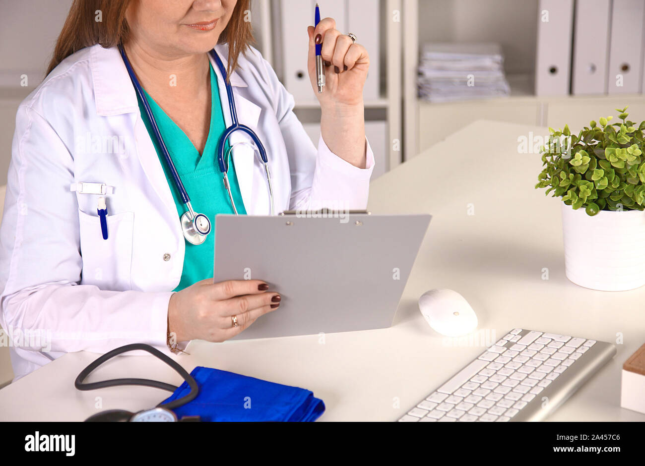 Female doctor at the desk in the office Stock Photo - Alamy