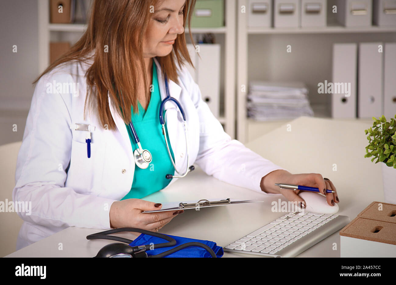 Female doctor at the desk in the office Stock Photo - Alamy