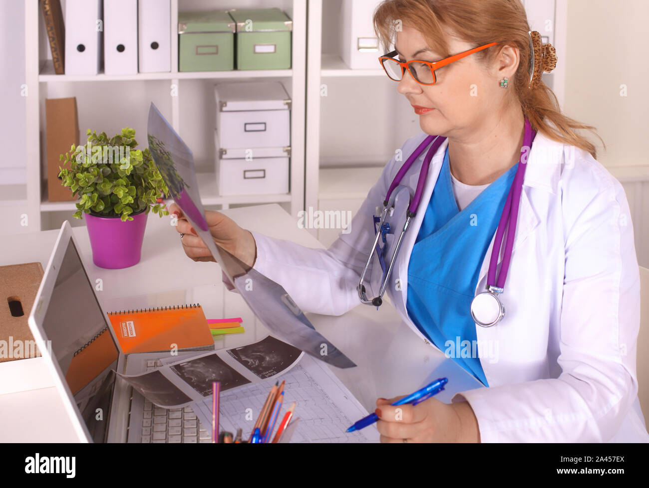 Female doctor at the desk in the office Stock Photo - Alamy