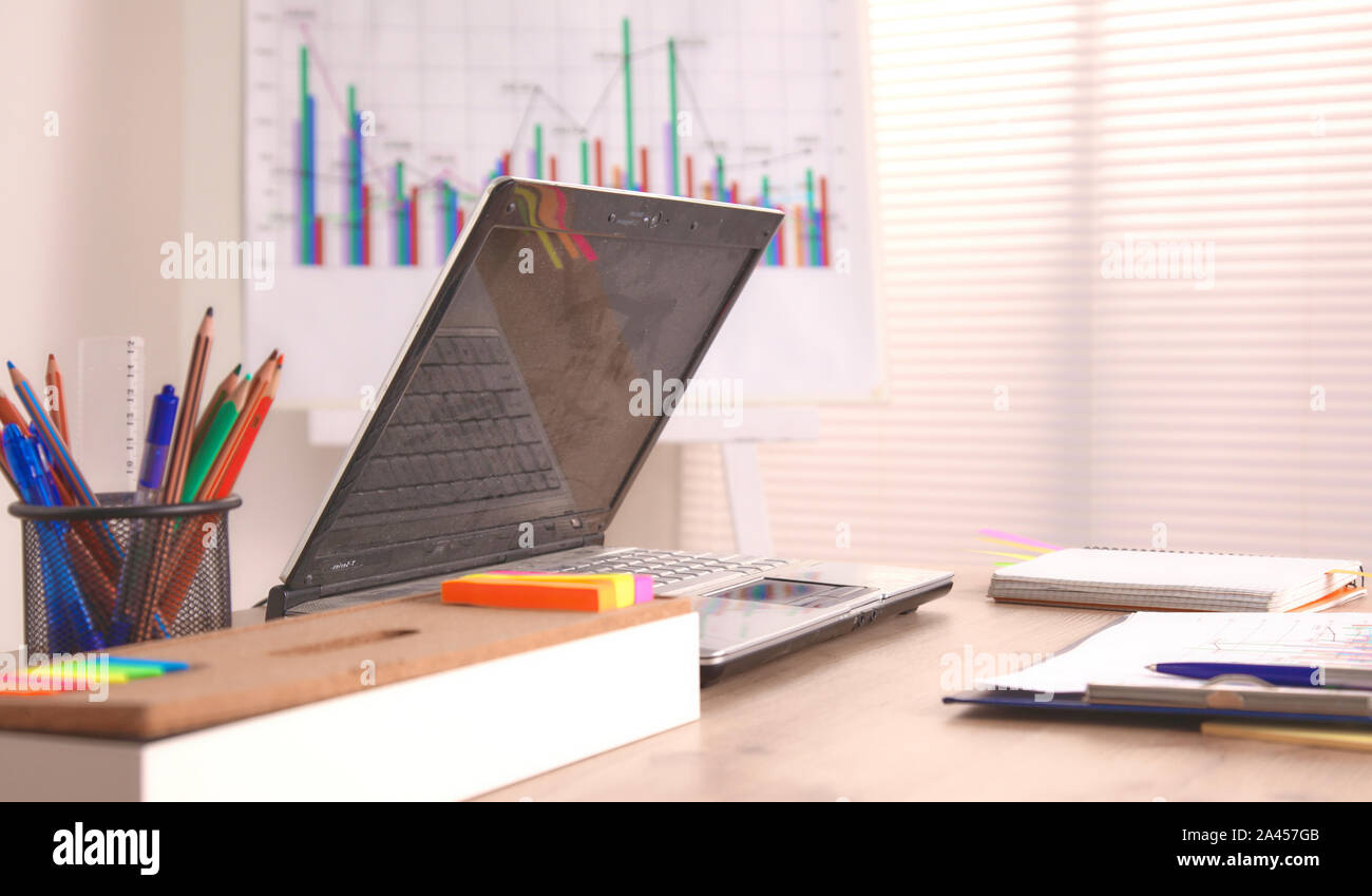 Office table with blank notepad and laptop Stock Photo - Alamy