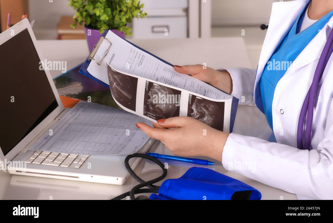 Female doctor at the desk in the office Stock Photo - Alamy