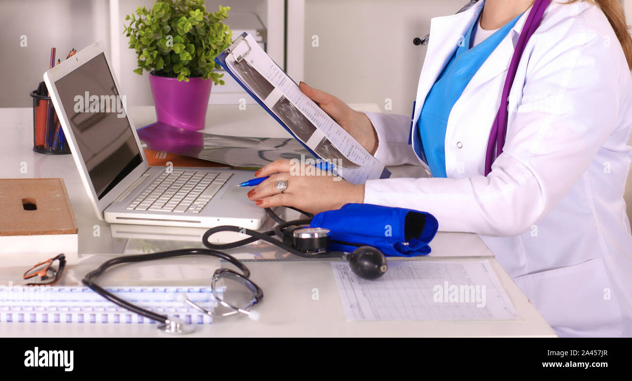 Female doctor at the desk in the office Stock Photo - Alamy