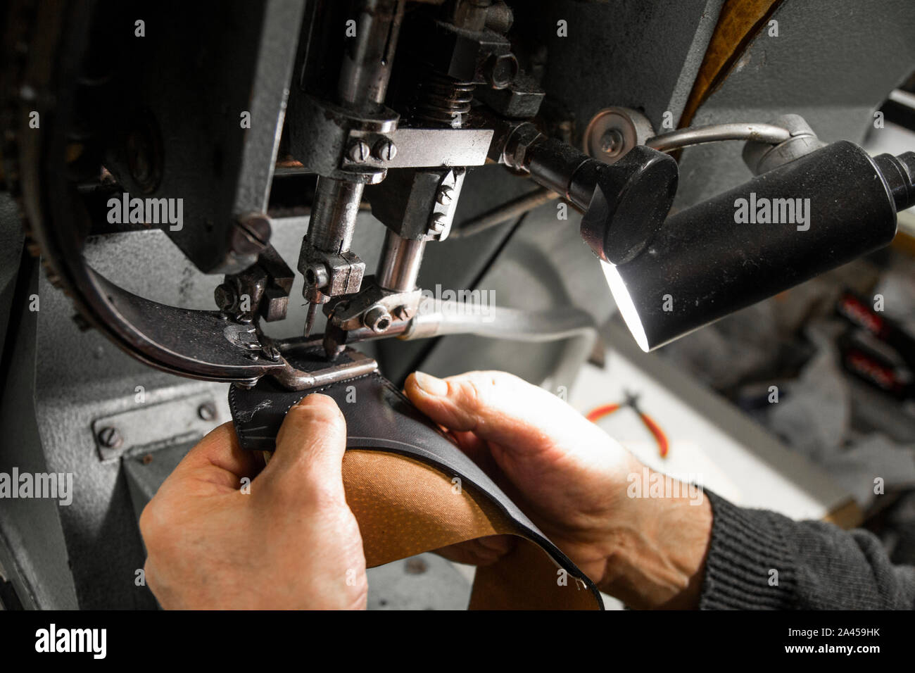 Man use special machine tool for making a shoes. The conveyor on a ...
