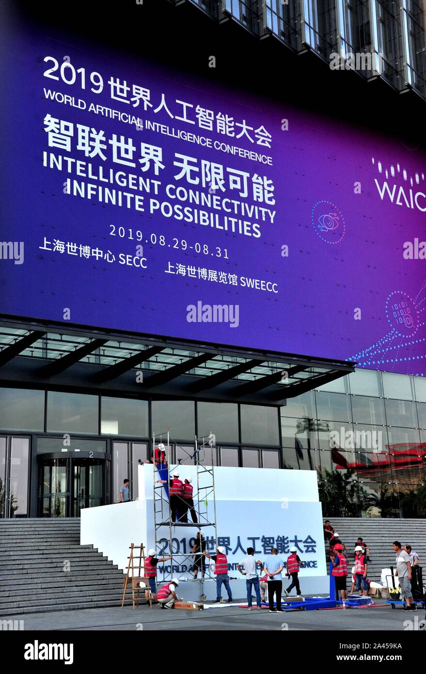 Chinese workers prepare for 2019 World Artificial Intelligence Conference (WAIC) at the Shanghai ...
