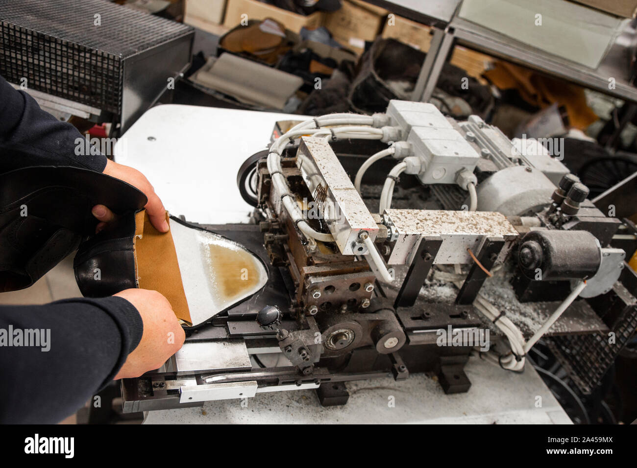 Man use special machine tool for making a shoes. The conveyor on a ...