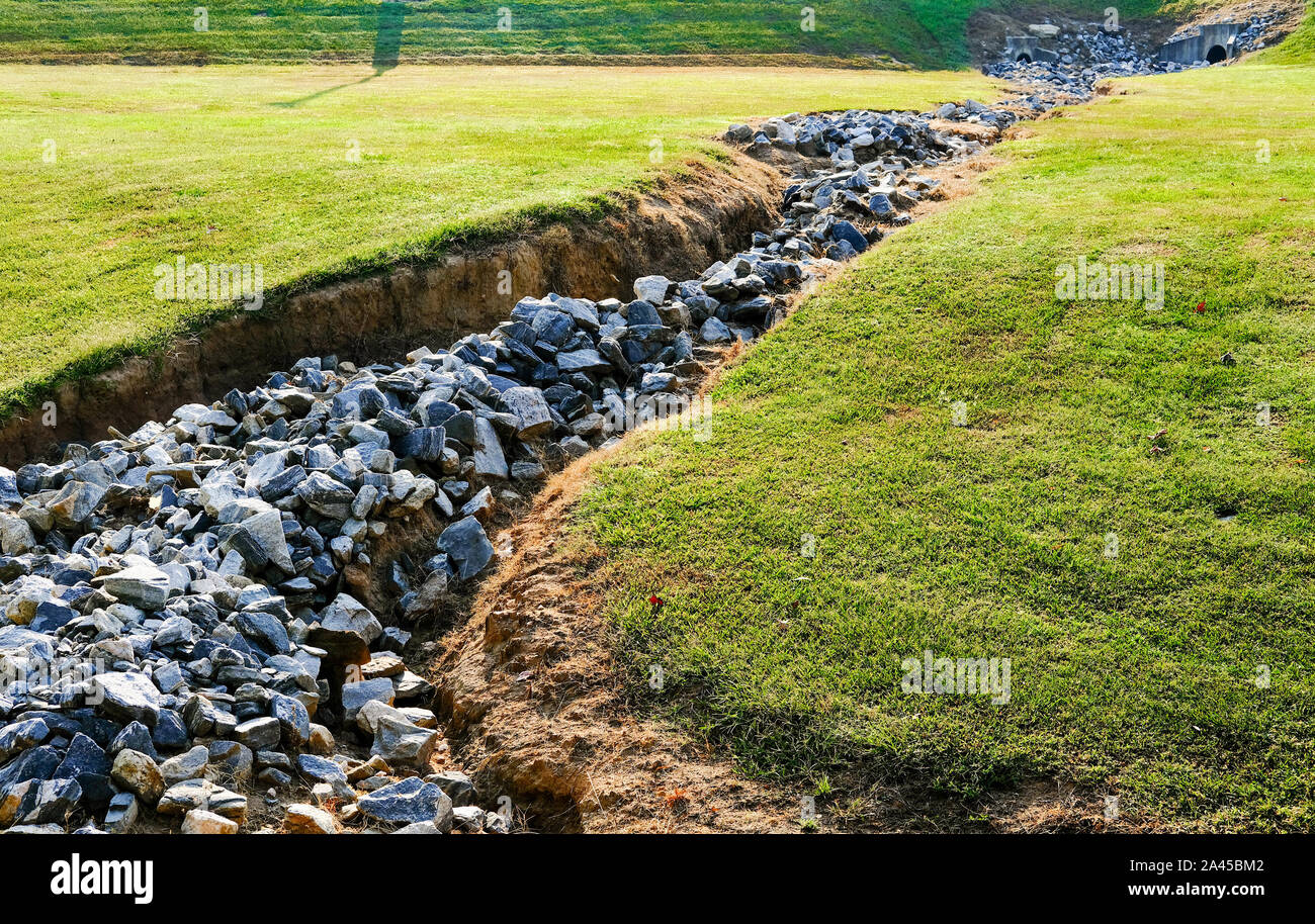 Large Granite Rocks in Drainage Ditch in Green Field Stock Photo - Alamy