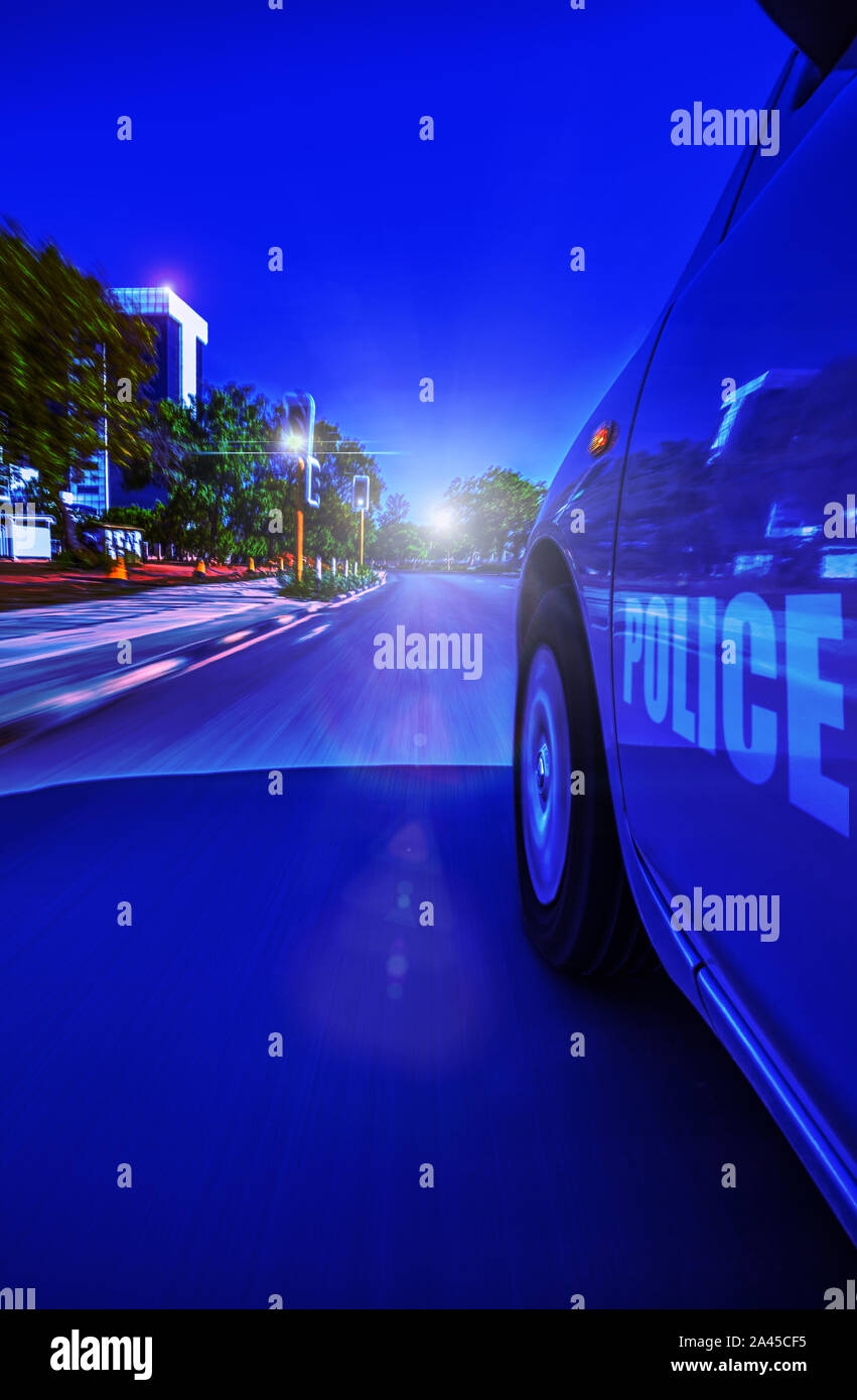 Police Sedan car speeding in the night through traffic lights, motion ...