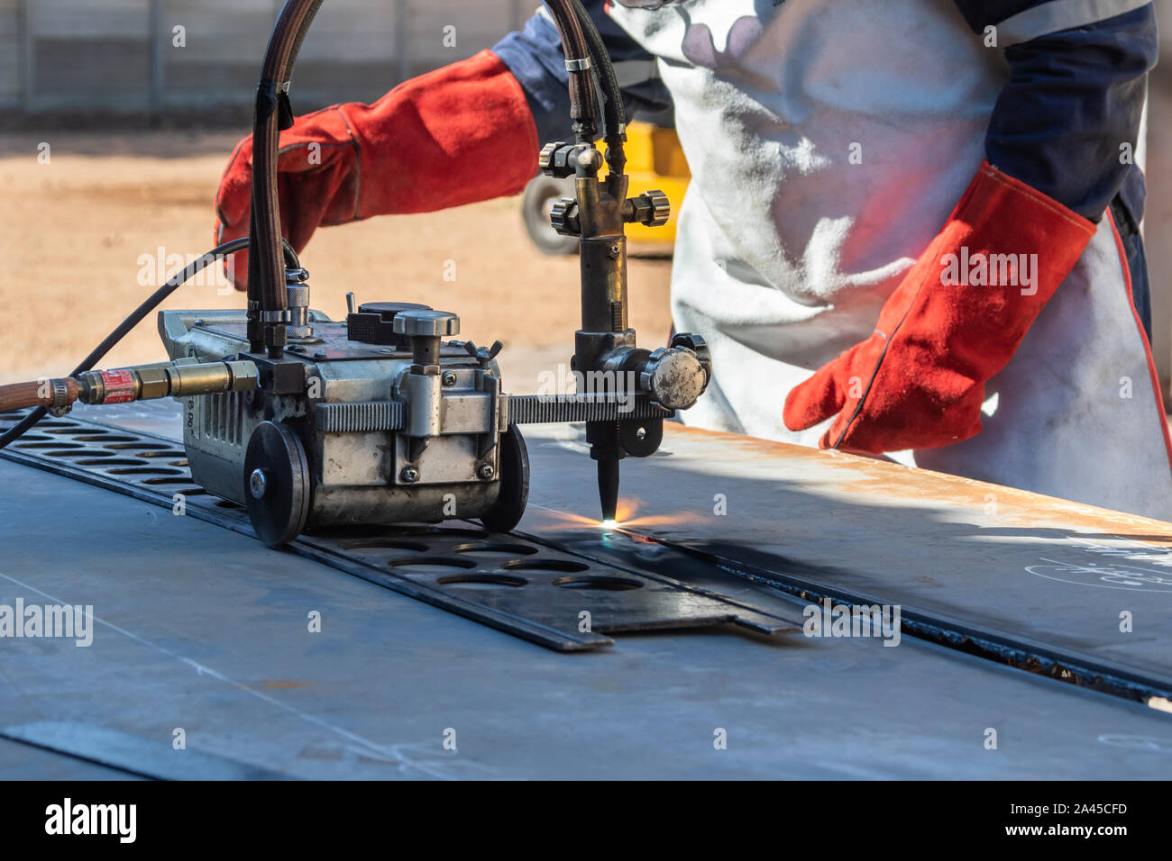 Motswana welder worker in a Botswana workshop, using an acetylene torch ...