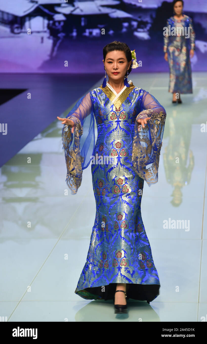 Elder models wearing traditional Chinese outfit designed by Chen Fumei ...