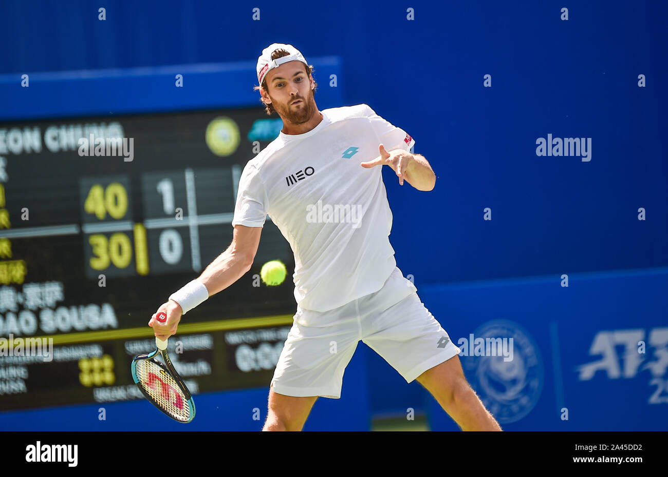 Joao Sousa of Portugal gets the ball against Chung Hyeon of South Korea at the first round of ...