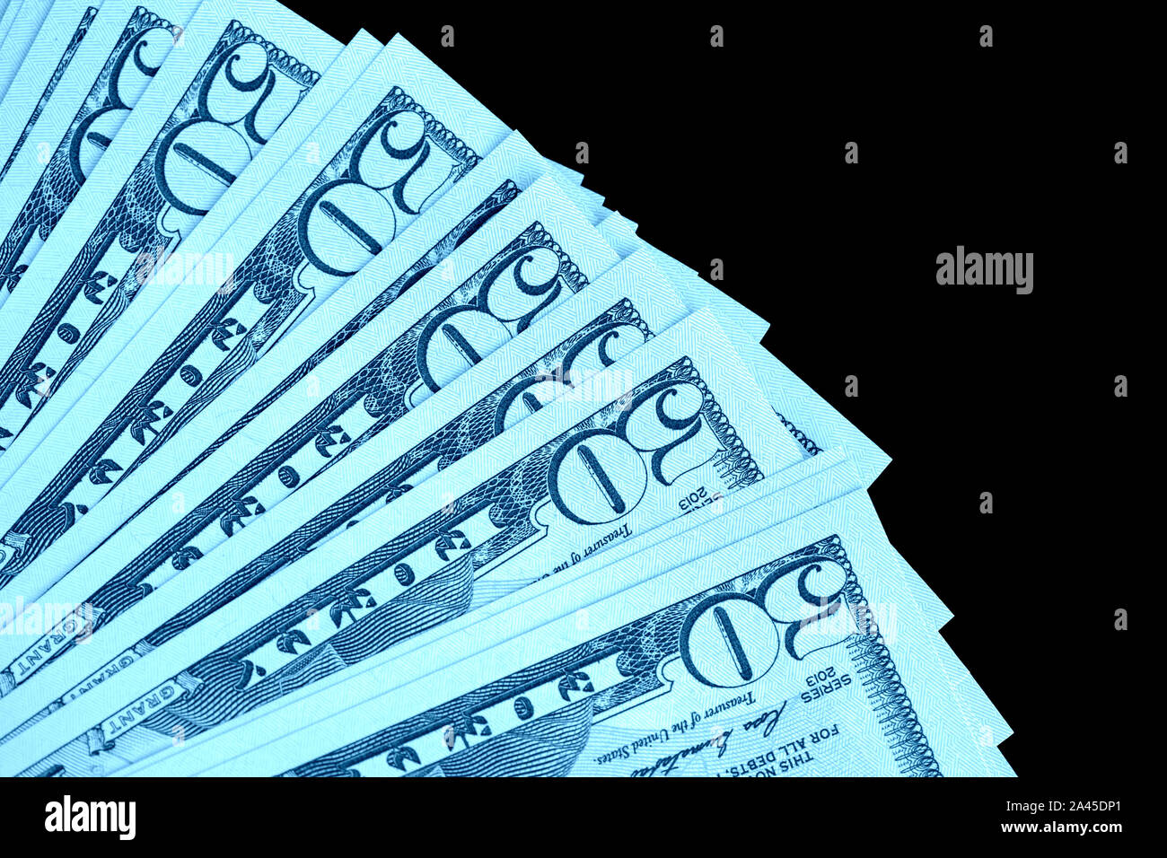 Fifty dollars banknotes isolated on black background close-up. Blue ...