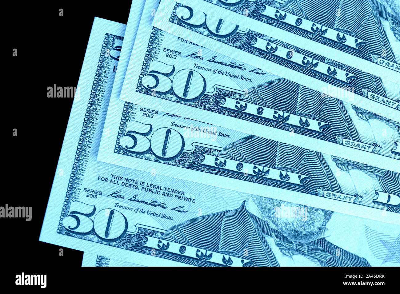 Fifty dollars banknotes isolated on black background close-up. Blue ...