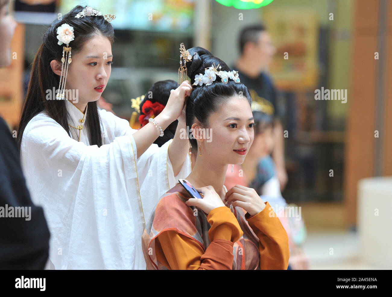 Beauties dressing in ancient Chinese clothes prepare to demonstrate and ...
