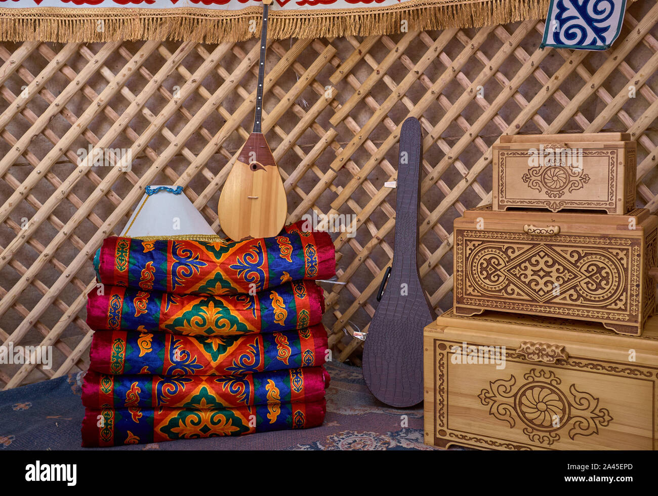 Wooden dowry chest near some asian carpets and some other traditional ...