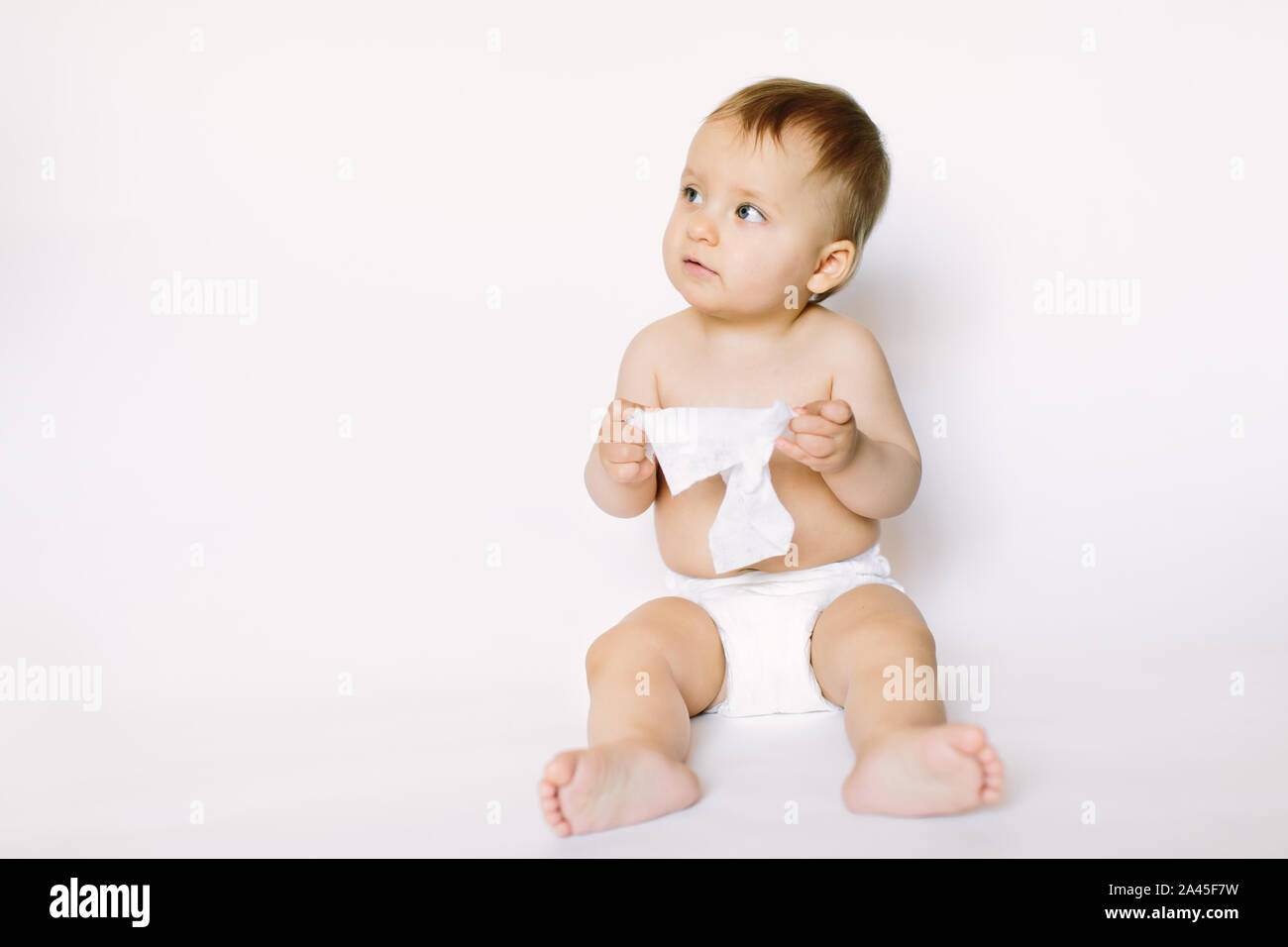 Hygiene - little baby girl get wet wipes, and wipes her face isolated ...