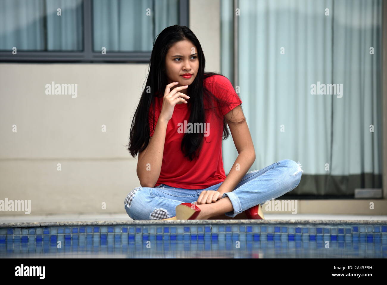 Female Youngster Thinking Sitting By Pool Stock Photo - Alamy