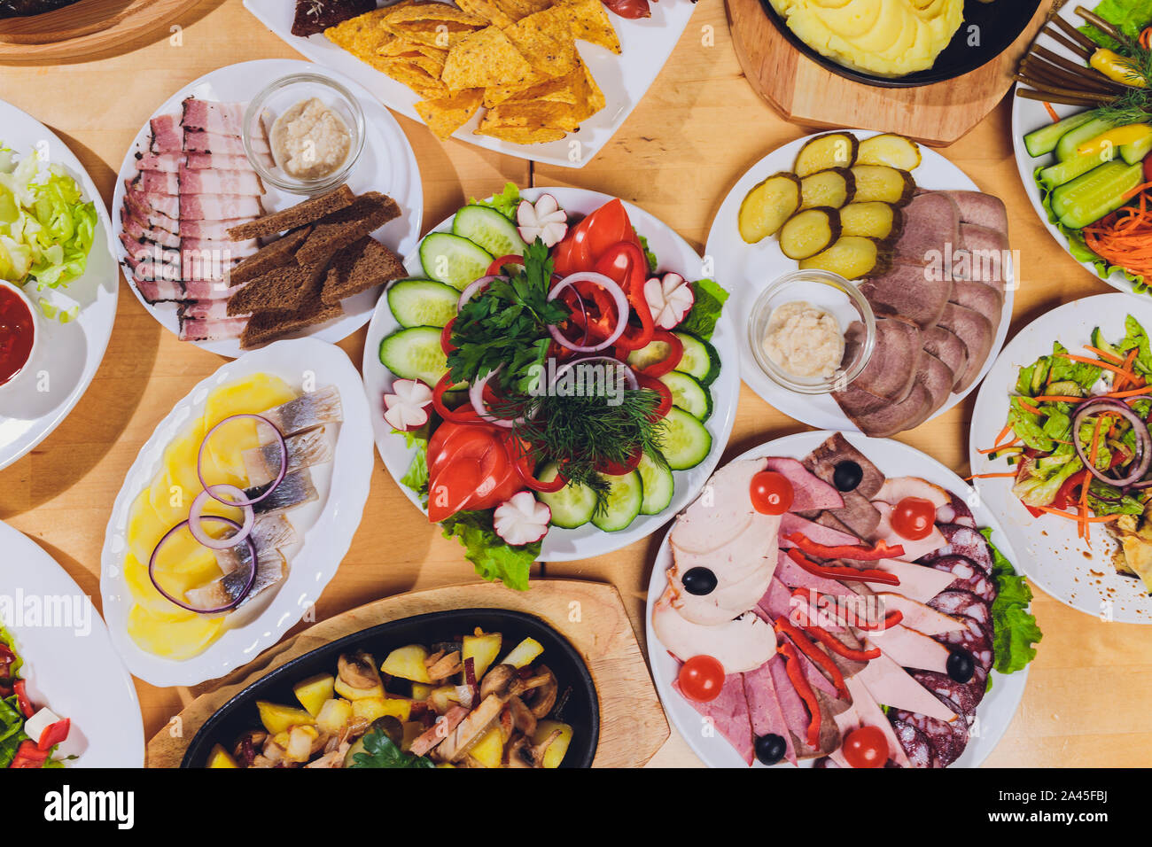 Food tray with delicious salami, pieces of sliced ham, sausage and ...