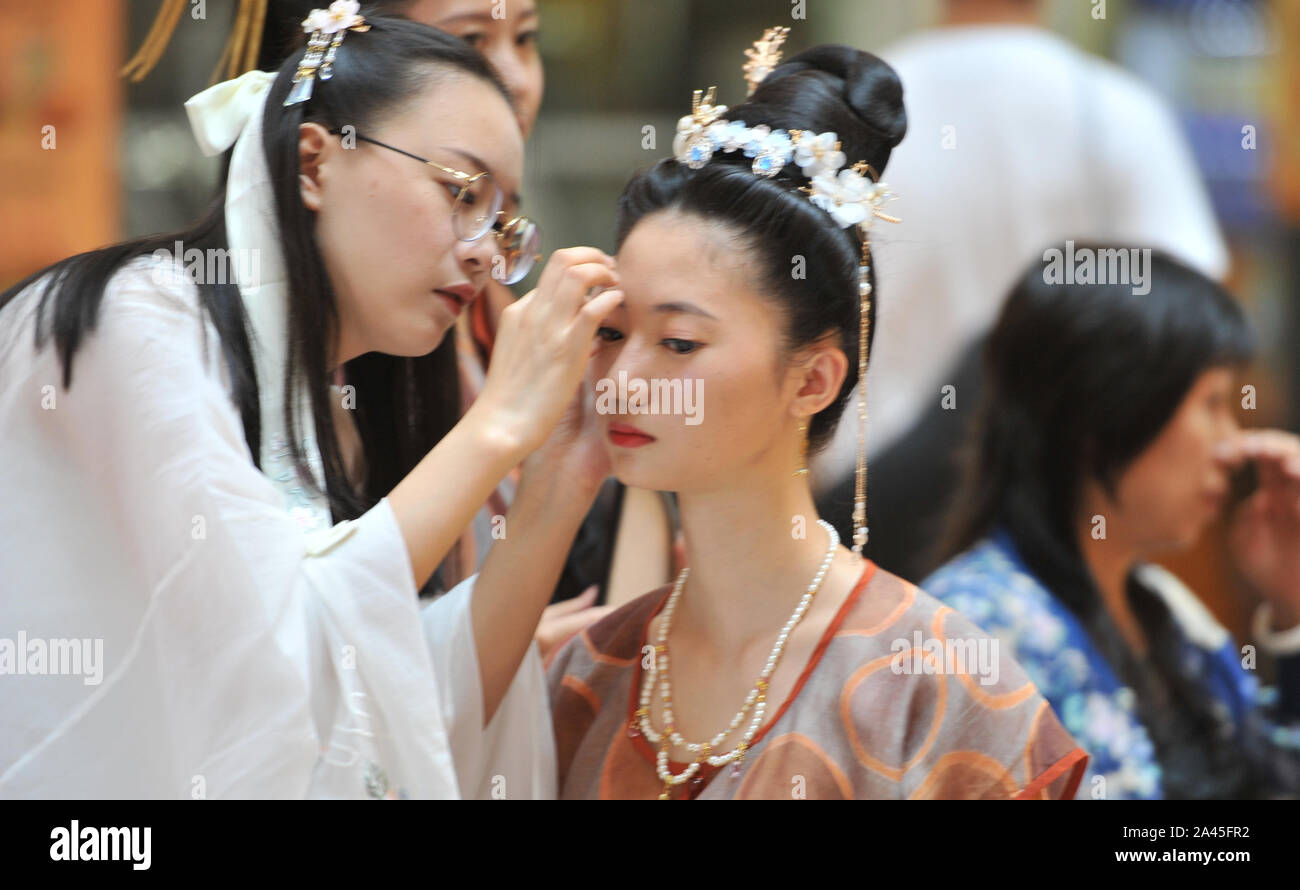 Beauties dressing in ancient Chinese clothes prepare to demonstrate and ...
