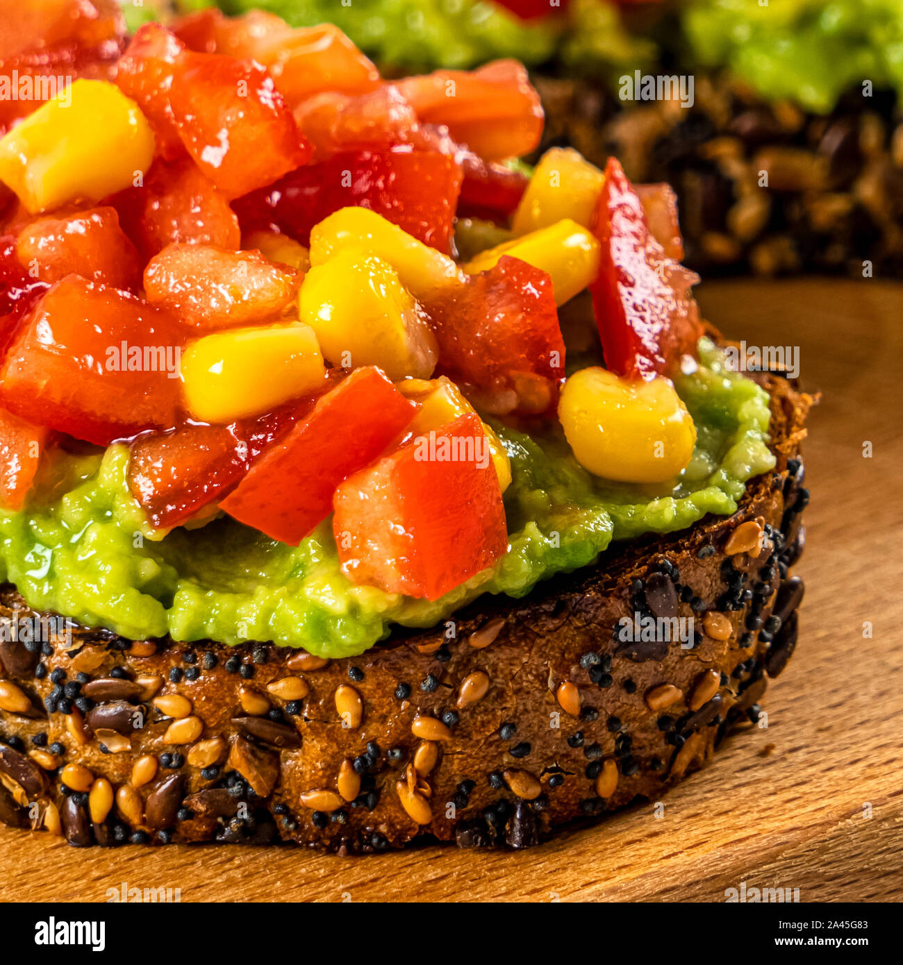 Avocado And Sweetcorn Salad On Toast With Tomatoes Stock Photo - Alamy