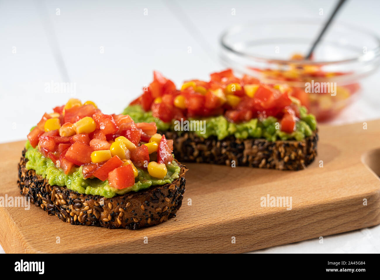 Avocado And Sweetcorn Salad On Toast With Tomatoes Stock Photo - Alamy