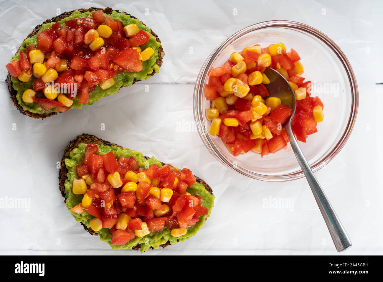 Avocado And Sweetcorn Salad On Toast With Tomatoes Stock Photo - Alamy