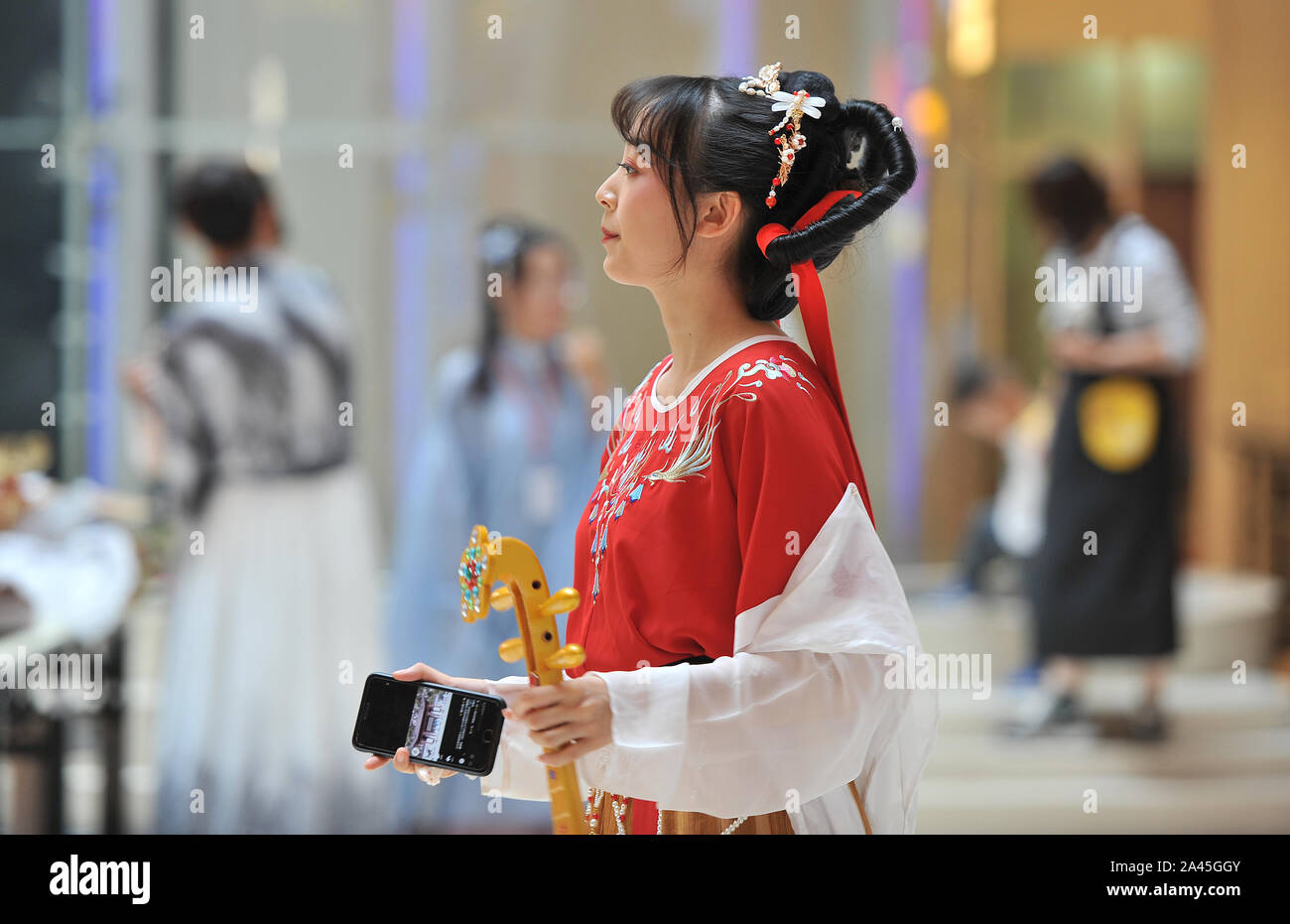 Beauties dressing in ancient Chinese clothes prepare to demonstrate and ...