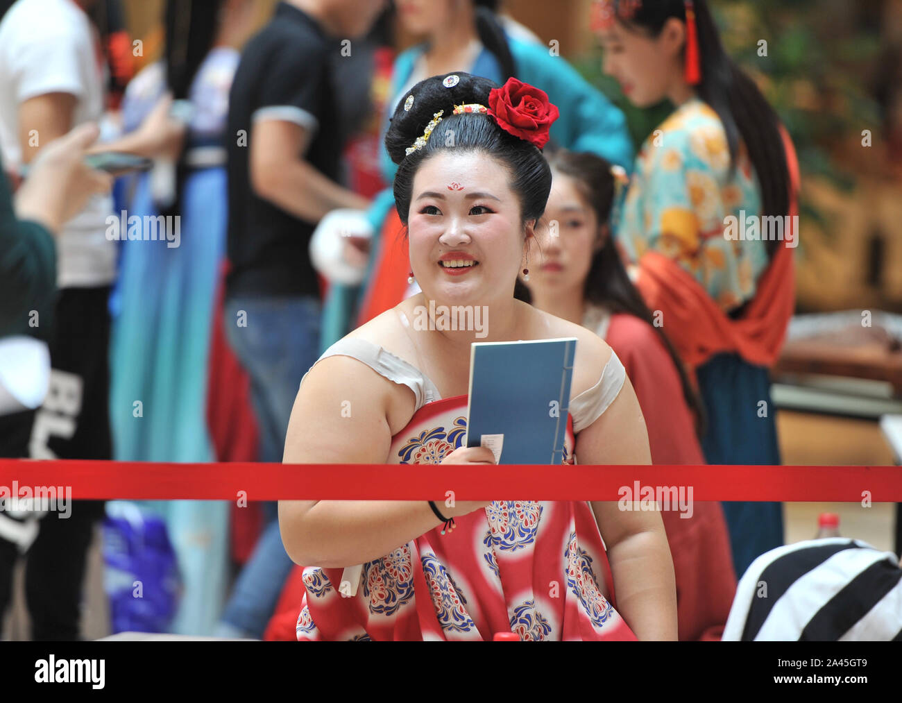 Beauties dressing in ancient Chinese clothes prepare to demonstrate and ...