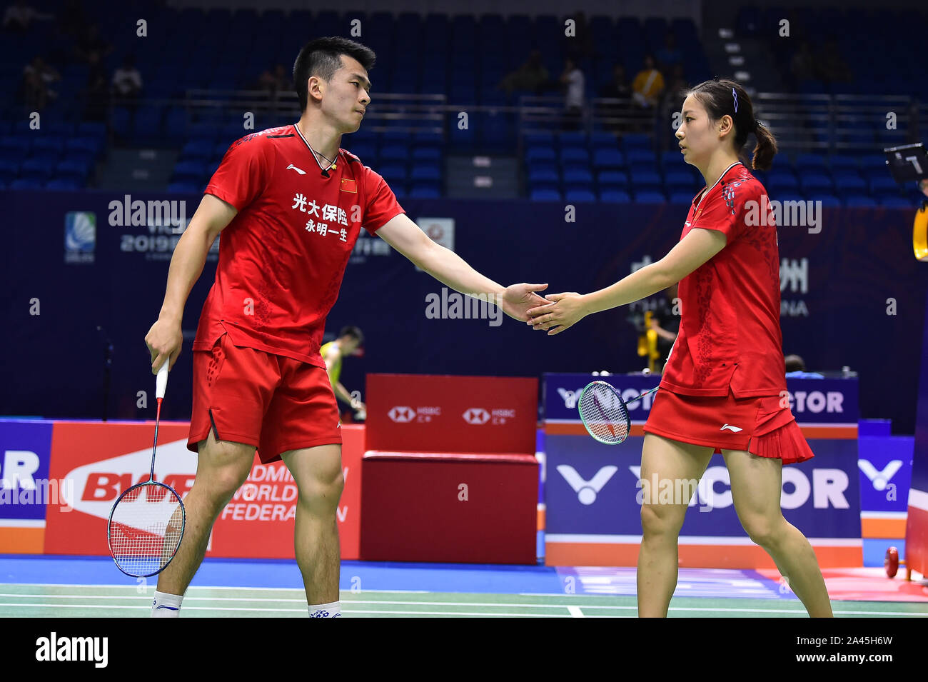 Chinese professional badminton players Zheng Siwei and Huang Yaqiong compete against Japanese ...