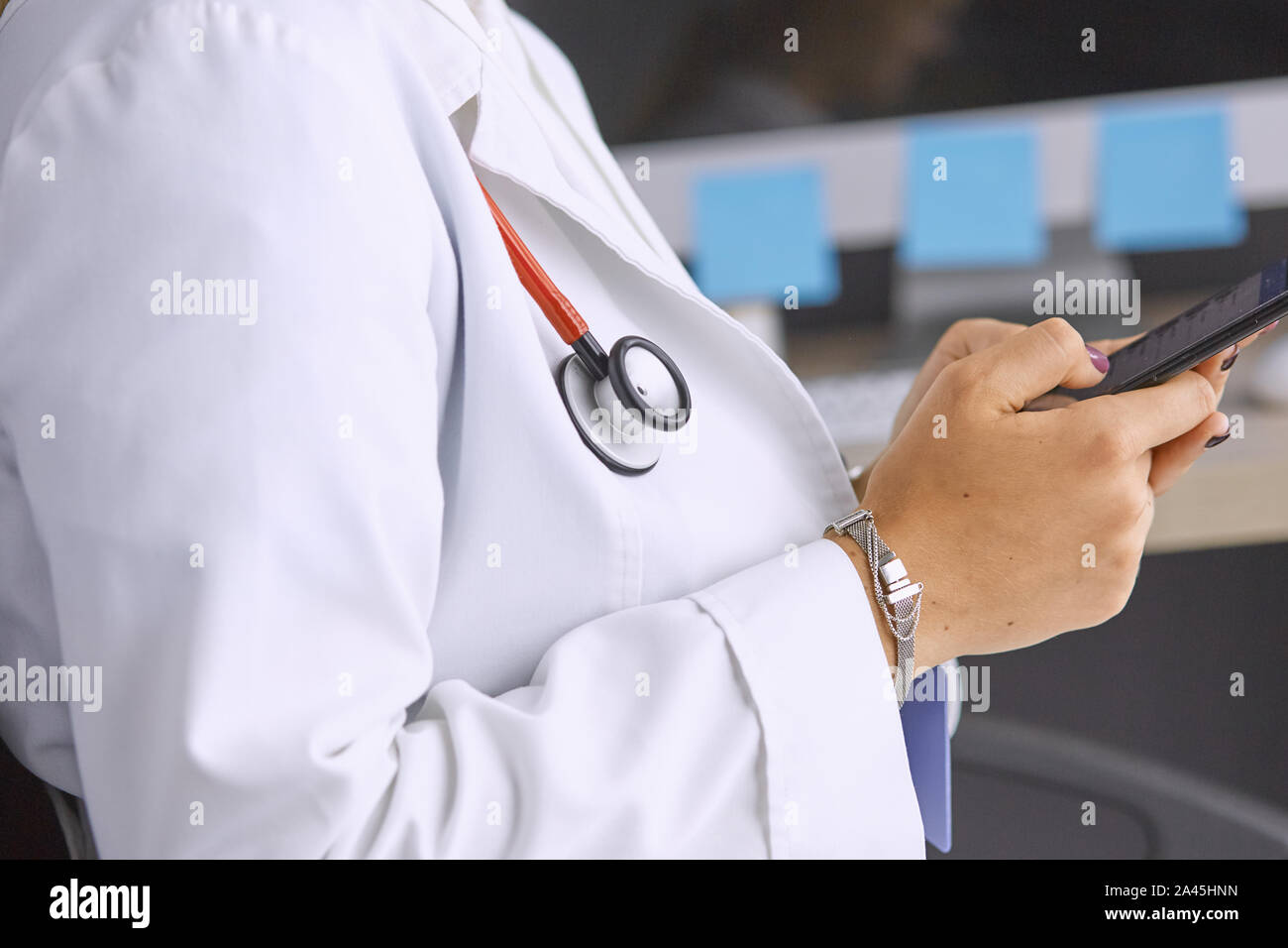female doctor between patients in the office talking on the phone Stock ...