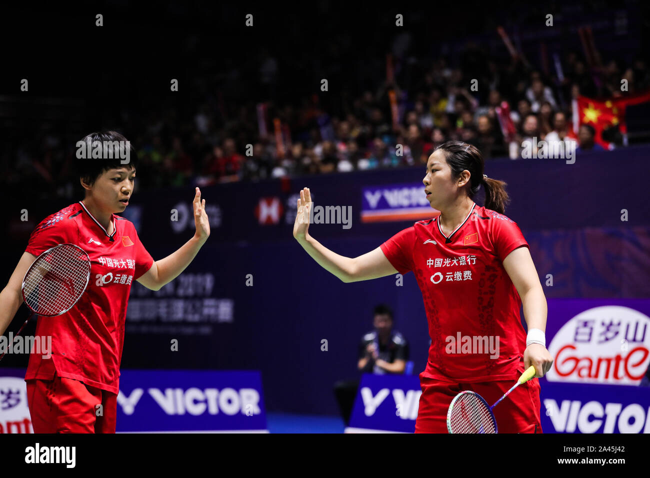 Chinese professional badminton players Jia Yifan and Chen Qingchen compete against Japanese ...