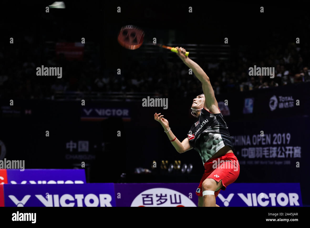 Japanese professional badminton player Kento Momota competes against ...
